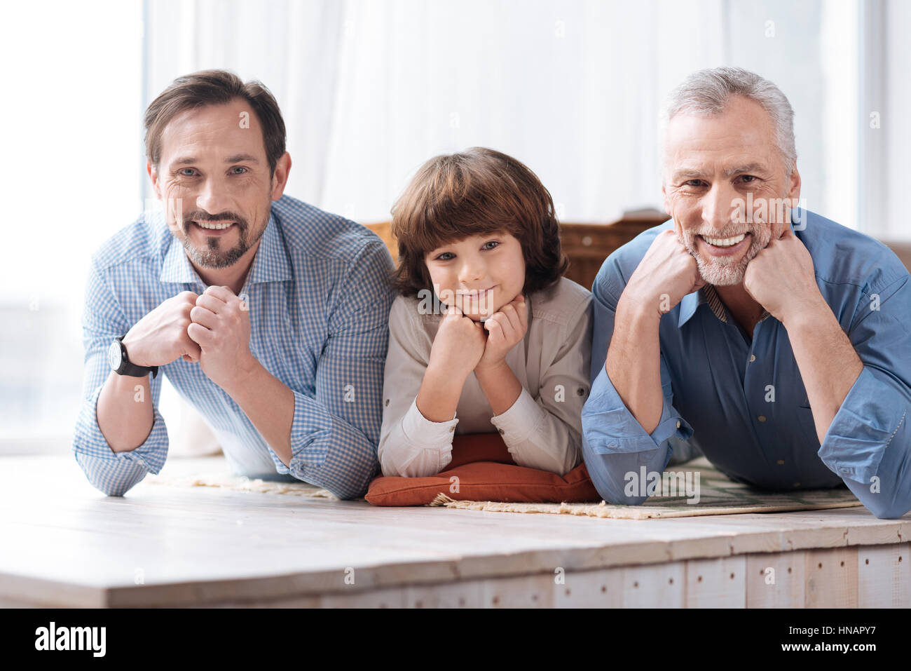 Positive happy family looking at you Stock Photo - Alamy