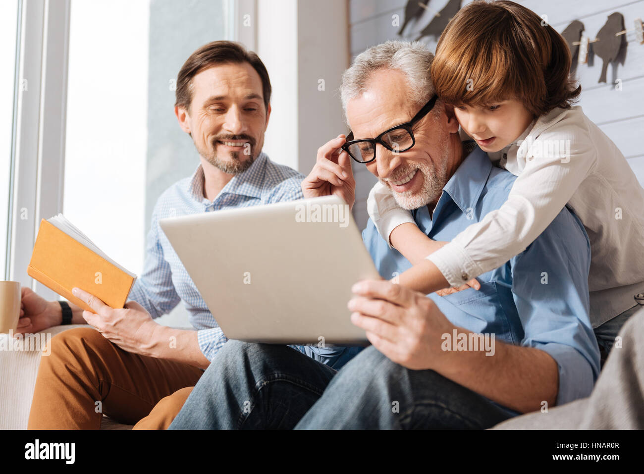 Pleasant cute boy pointing at the laptop screen Stock Photo - Alamy