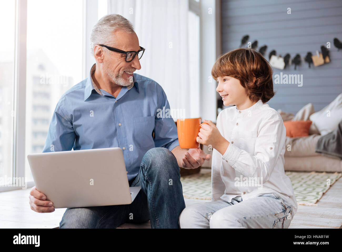 Cute happy boy having tea Stock Photo - Alamy