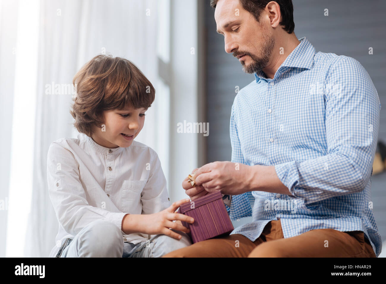 Handsome nice man tying a bow Stock Photo - Alamy