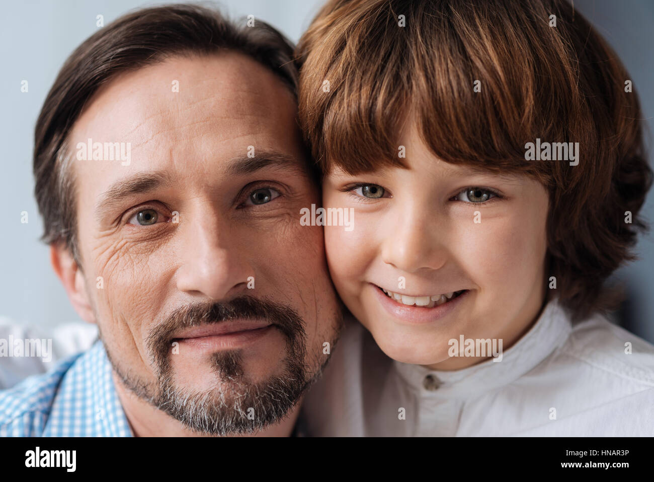 Portrait of father and son being together Stock Photo - Alamy