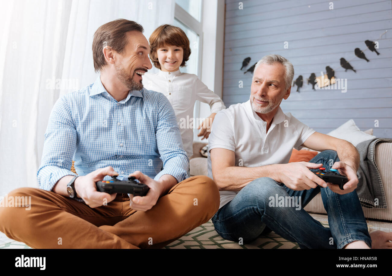 Happy delighted man holding a game console Stock Photo - Alamy