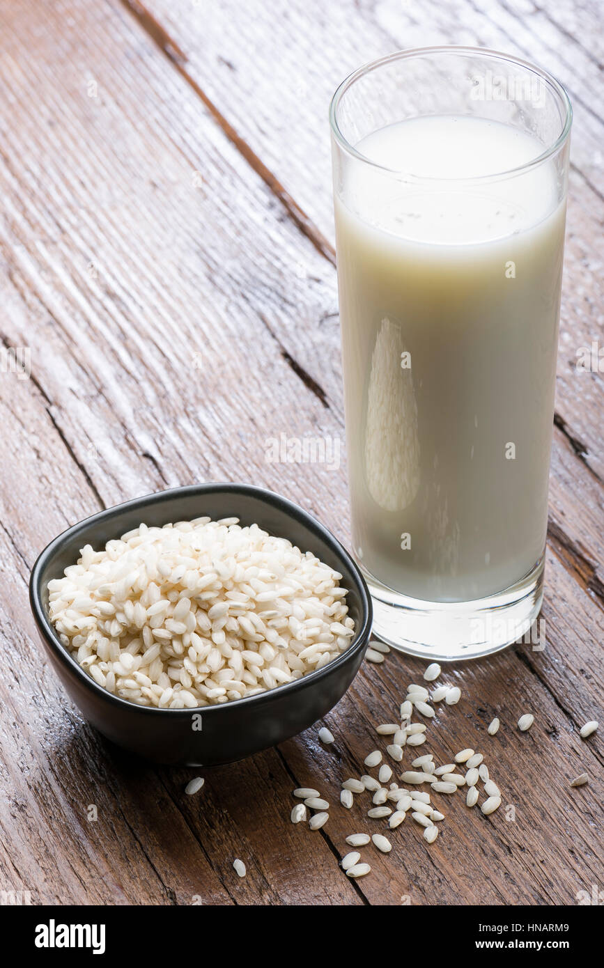 glass of rice milk with rice grains on wooden table Stock Photo - Alamy