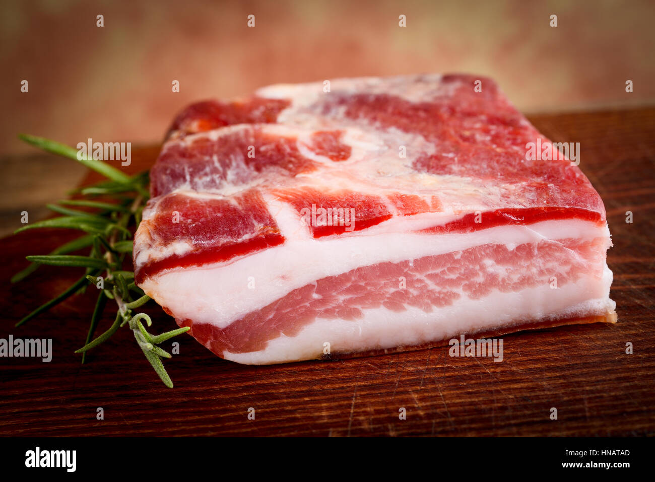 italian bacon pancetta on wooden chopping board - italian food Stock ...