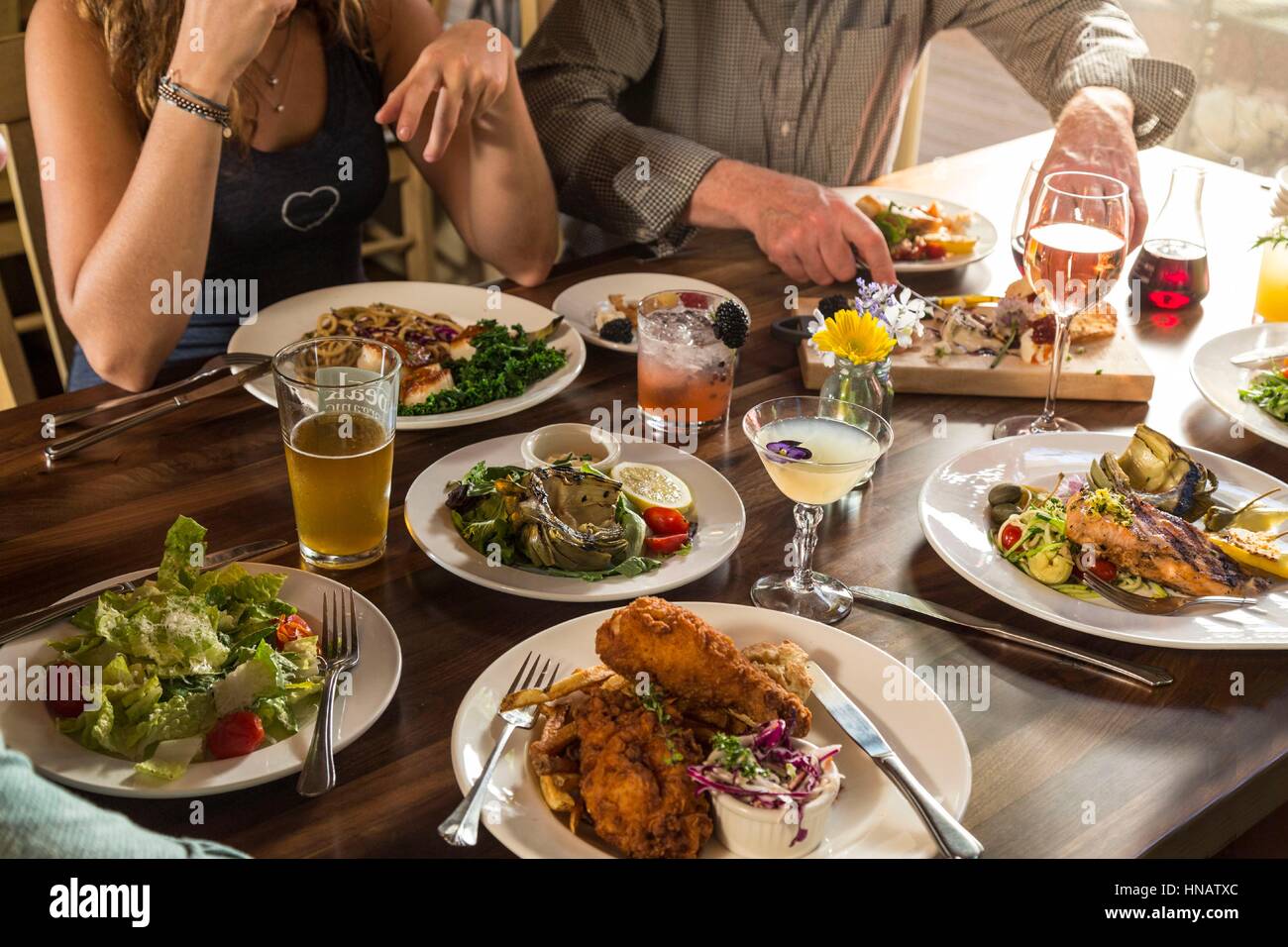 Restaurant table with food and cocktails Stock Photo - Alamy
