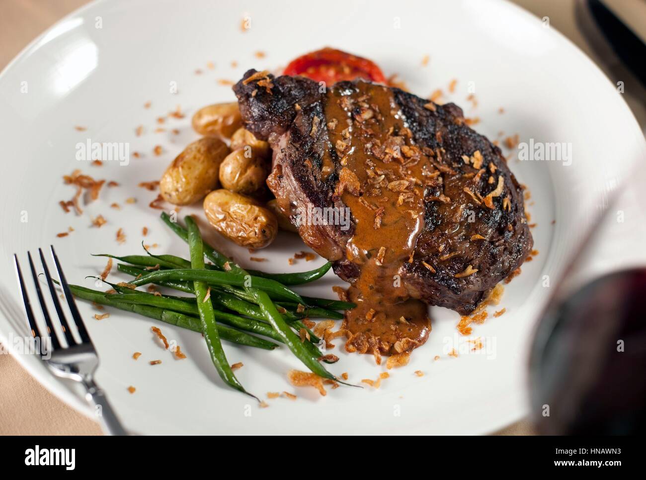 Porterhouse steak served with string beans and potatoes, David's ...