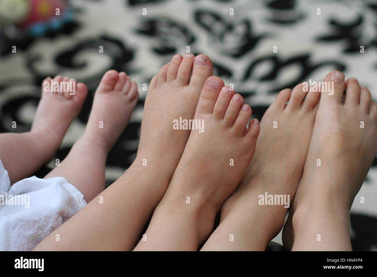 Three Childrens kids feet, barefoot, little piggies, toes Stock Photo ...