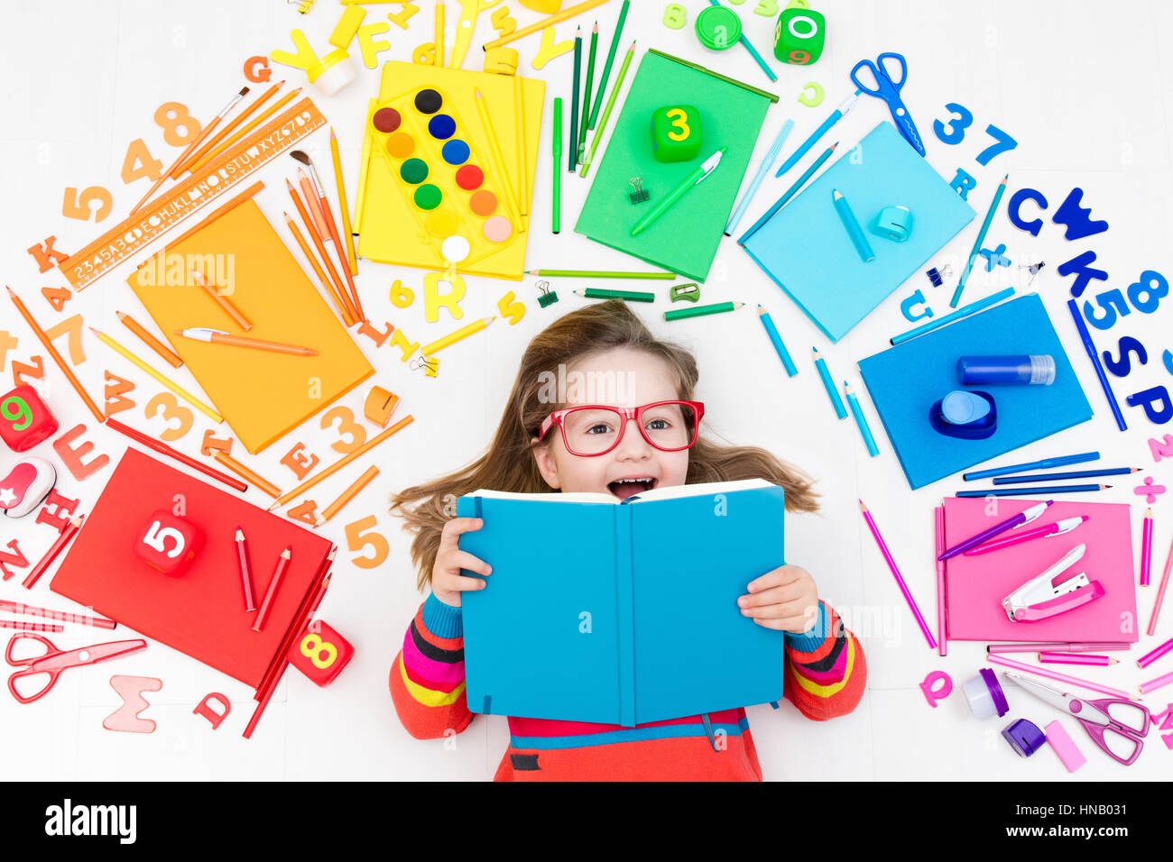 Little girl with school supplies, books, drawing and painting tools and ...