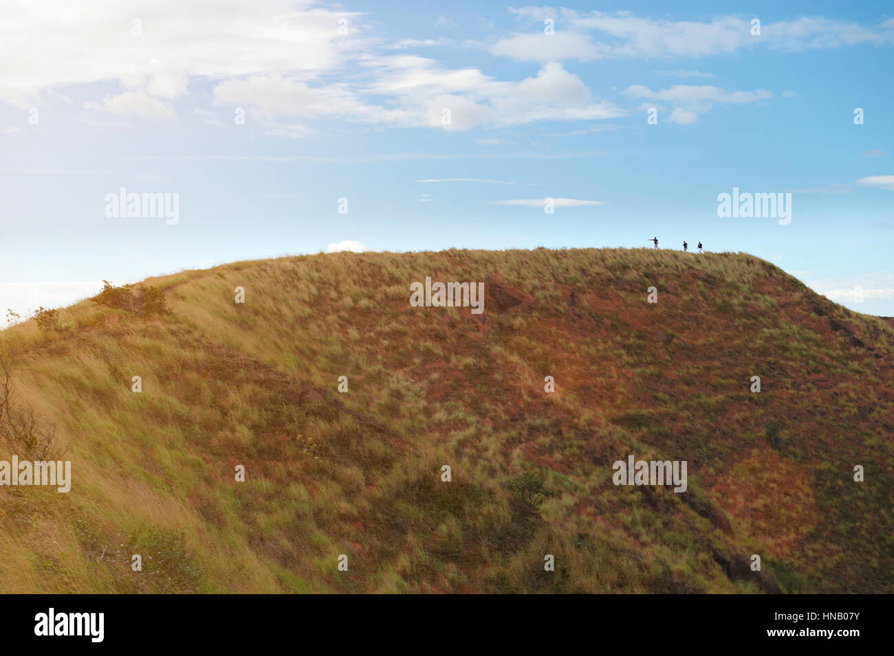group of people hiking on huge hill on sunny day Stock Photo - Alamy