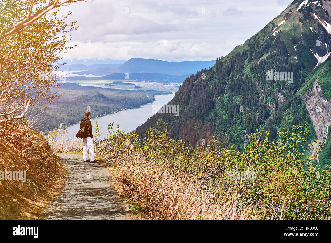 man in hiking path in alaska landscape scenery Stock Photo - Alamy