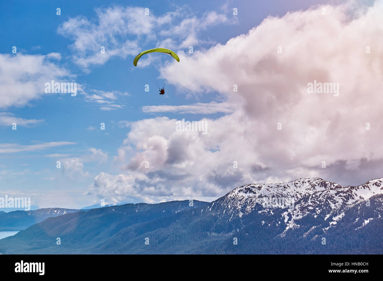 paraplane in blue sky with mountain skyline Stock Photo - Alamy