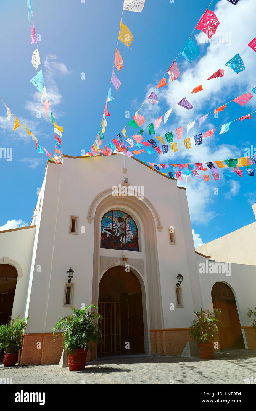 catholic church with colourful flags in blue sky Stock Photo - Alamy