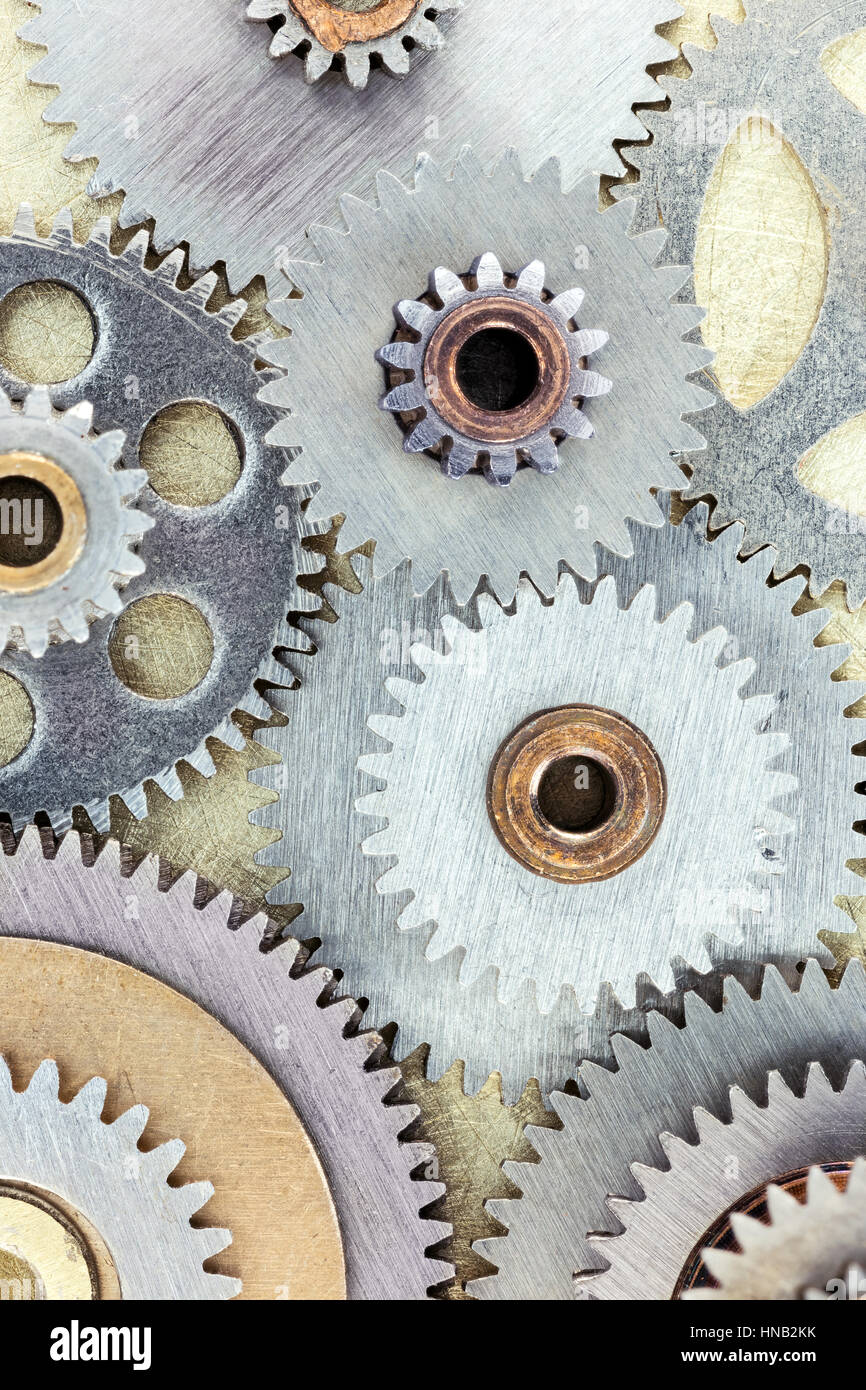 set of different cogwheel gears on metal background. detailed view ...