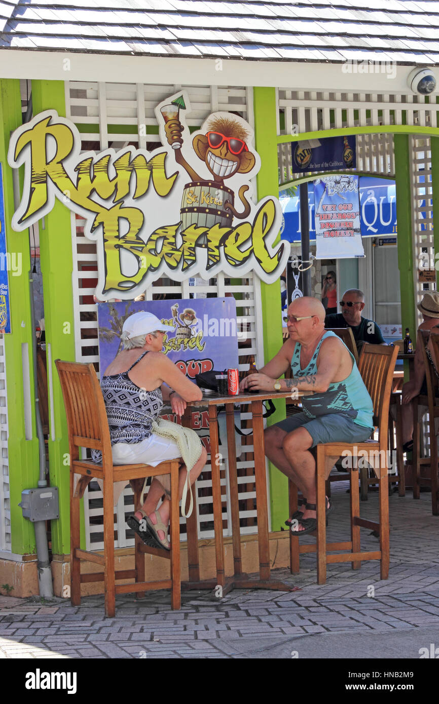 Middle aged couple drinking at Rum Barrel bar, Port Zante, Basseterre ...
