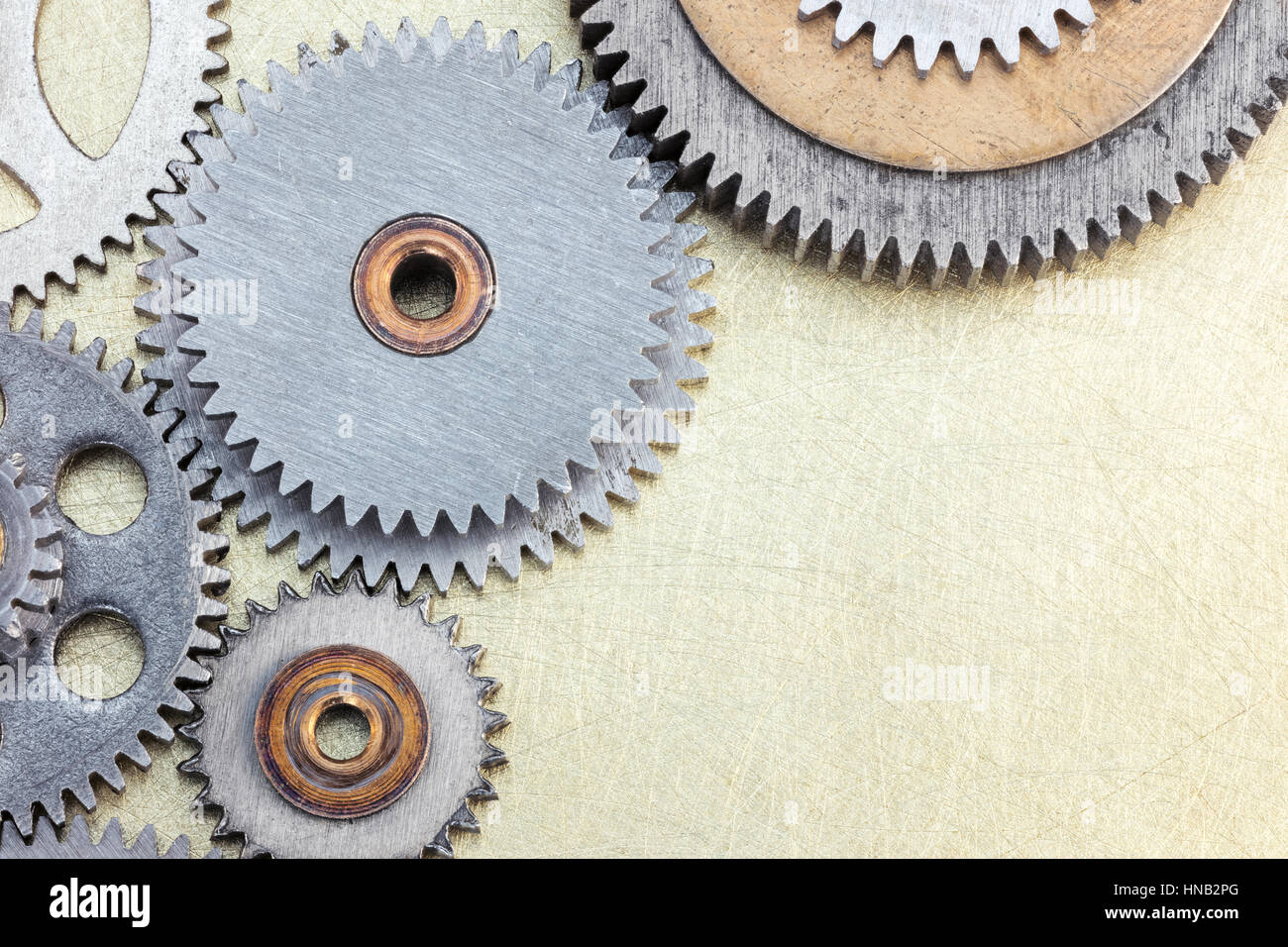 metal gear cogwheels on industrial scratched brass background Stock ...