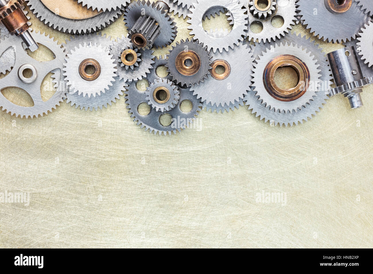 set of different gears and details of machines on brushed brass ...