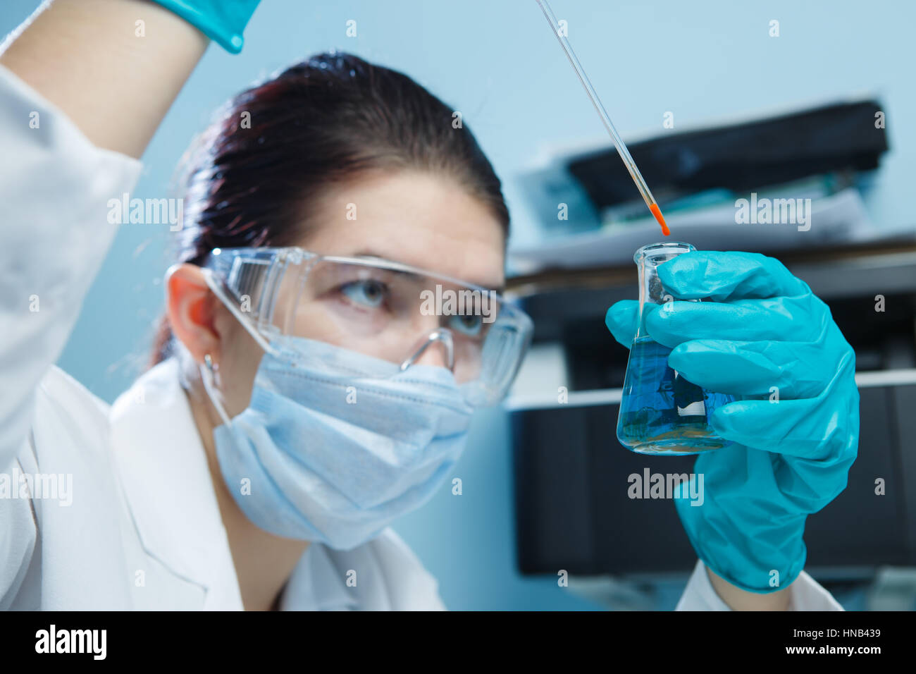 Laboratorian with safety glasses, flask in laboratory Stock Photo - Alamy