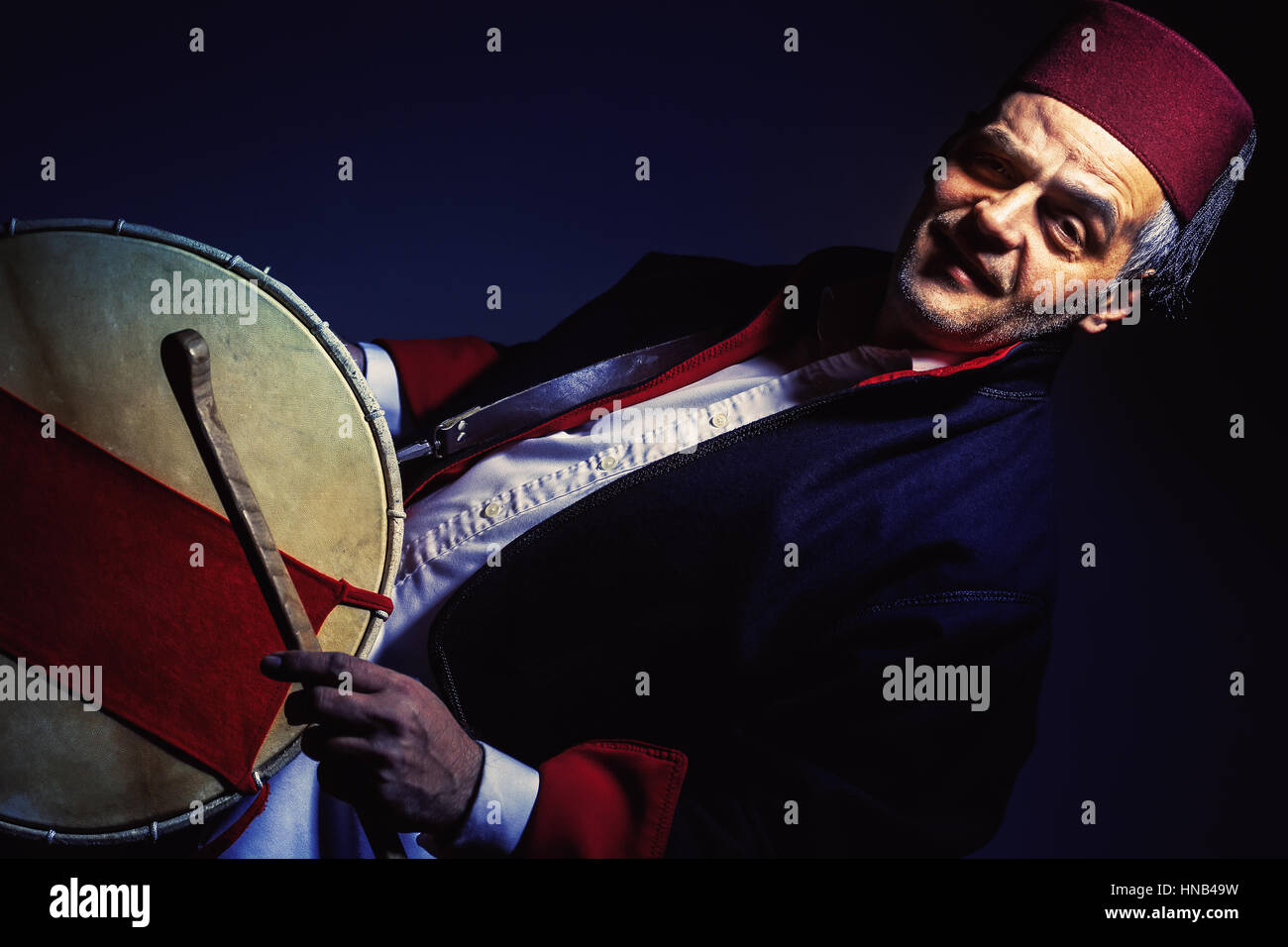 Portrait of a musician from Balkan, Macedonian style, wearing a fez hat ...
