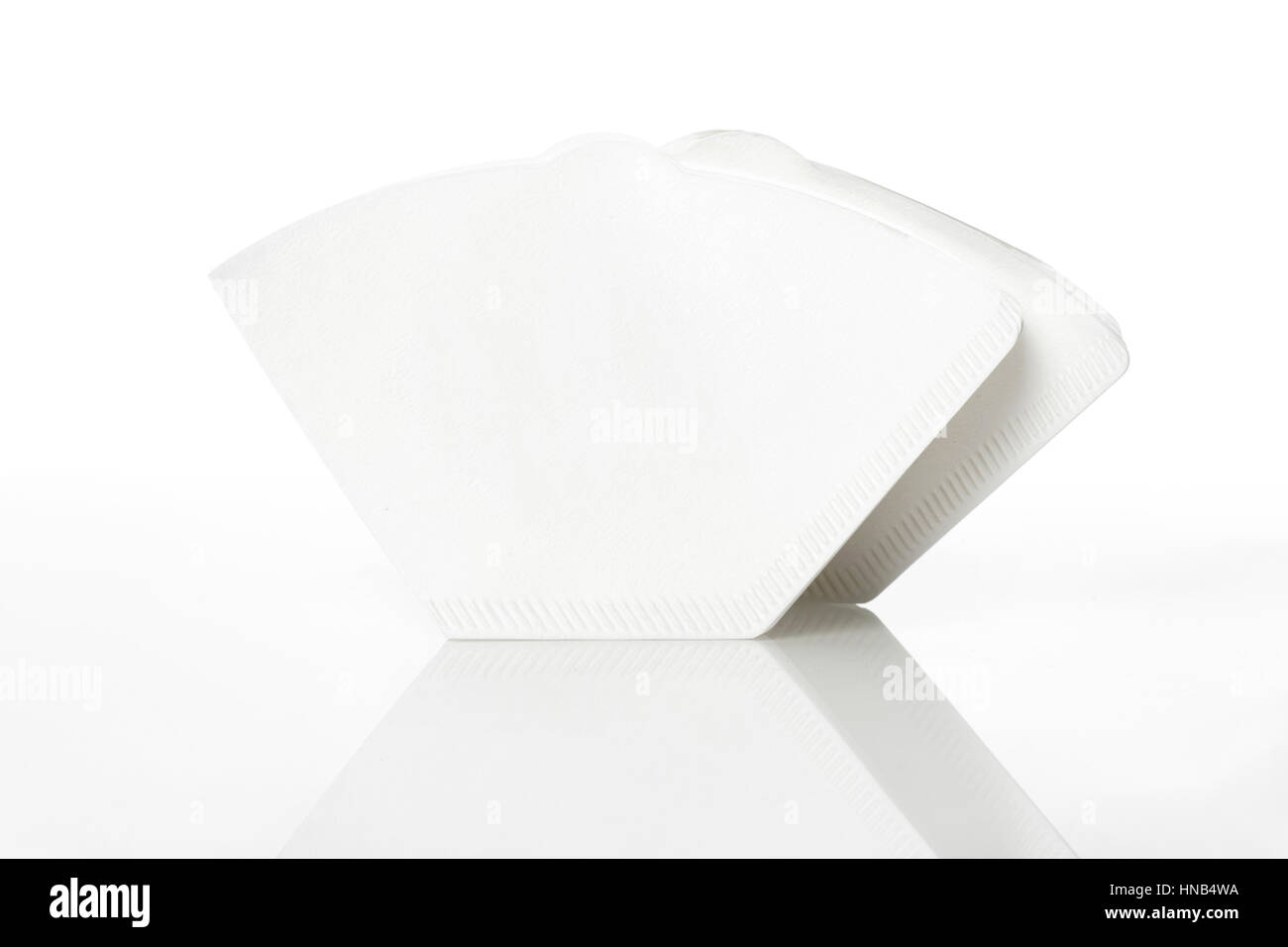 closeup white coffee filters on white background Stock Photo - Alamy