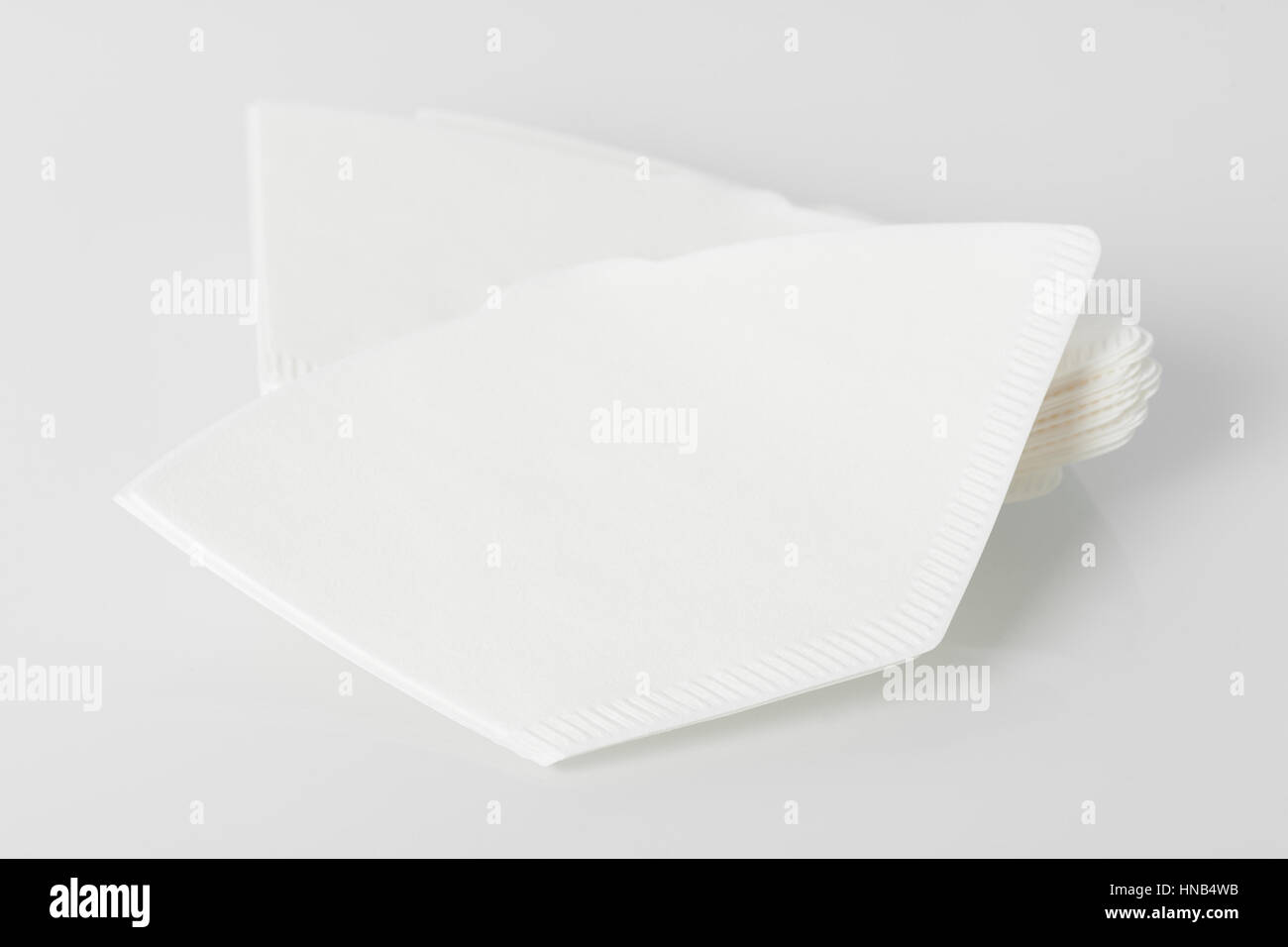 closeup white coffee filters on white background Stock Photo - Alamy