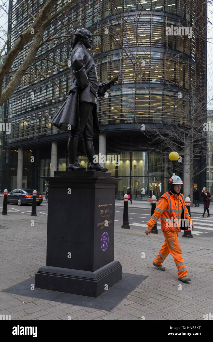 A workman walks past the statue of Member of parliament and Mayor John ...