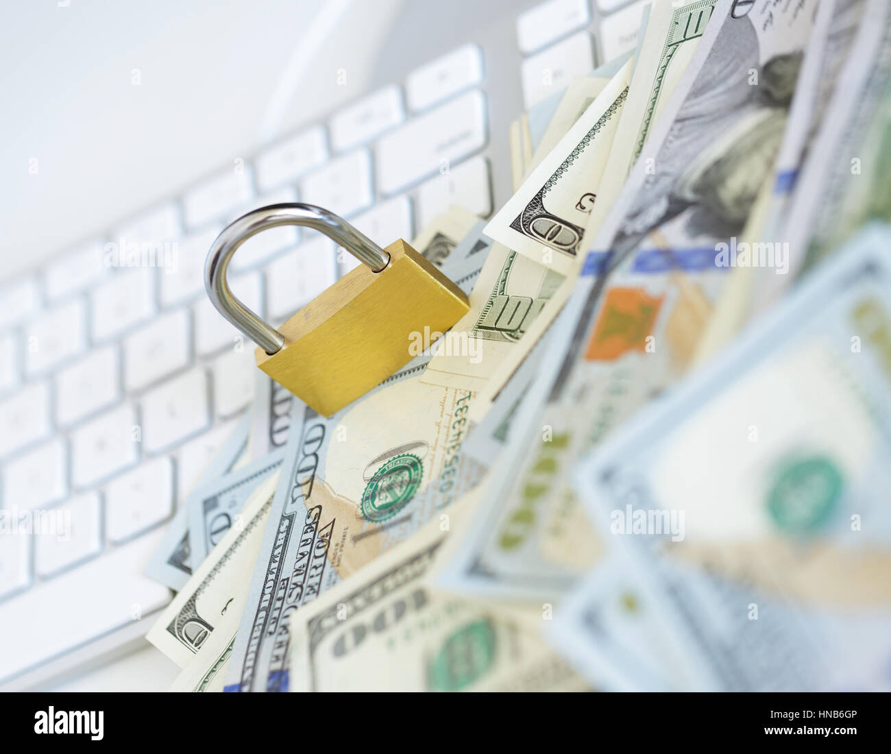 Security lock on dollar bills with white computer keyboard - breach of ...