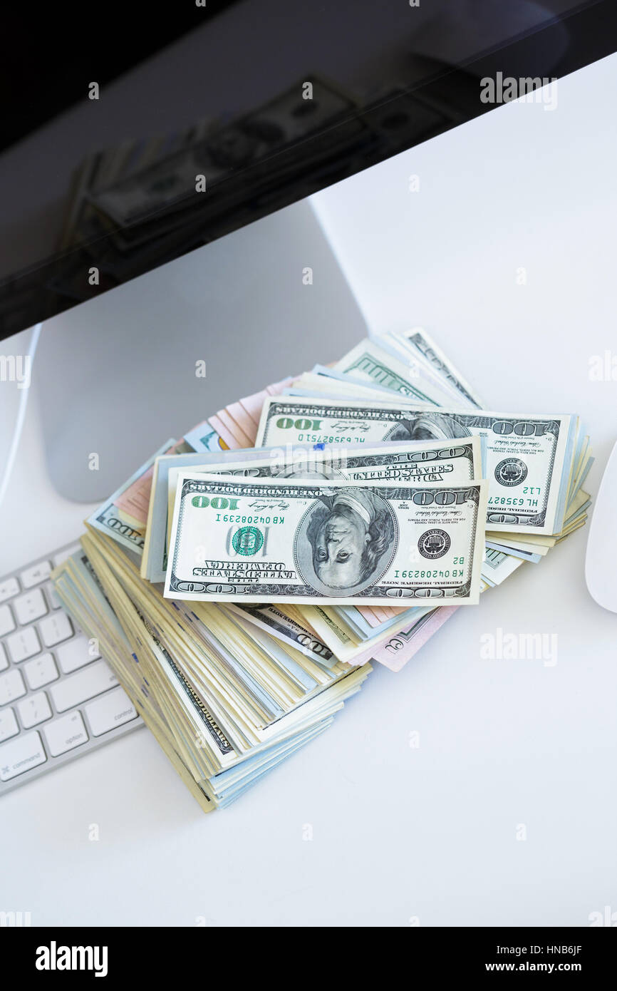 Dollar bills on the white computer keyboard - online payments concept ...