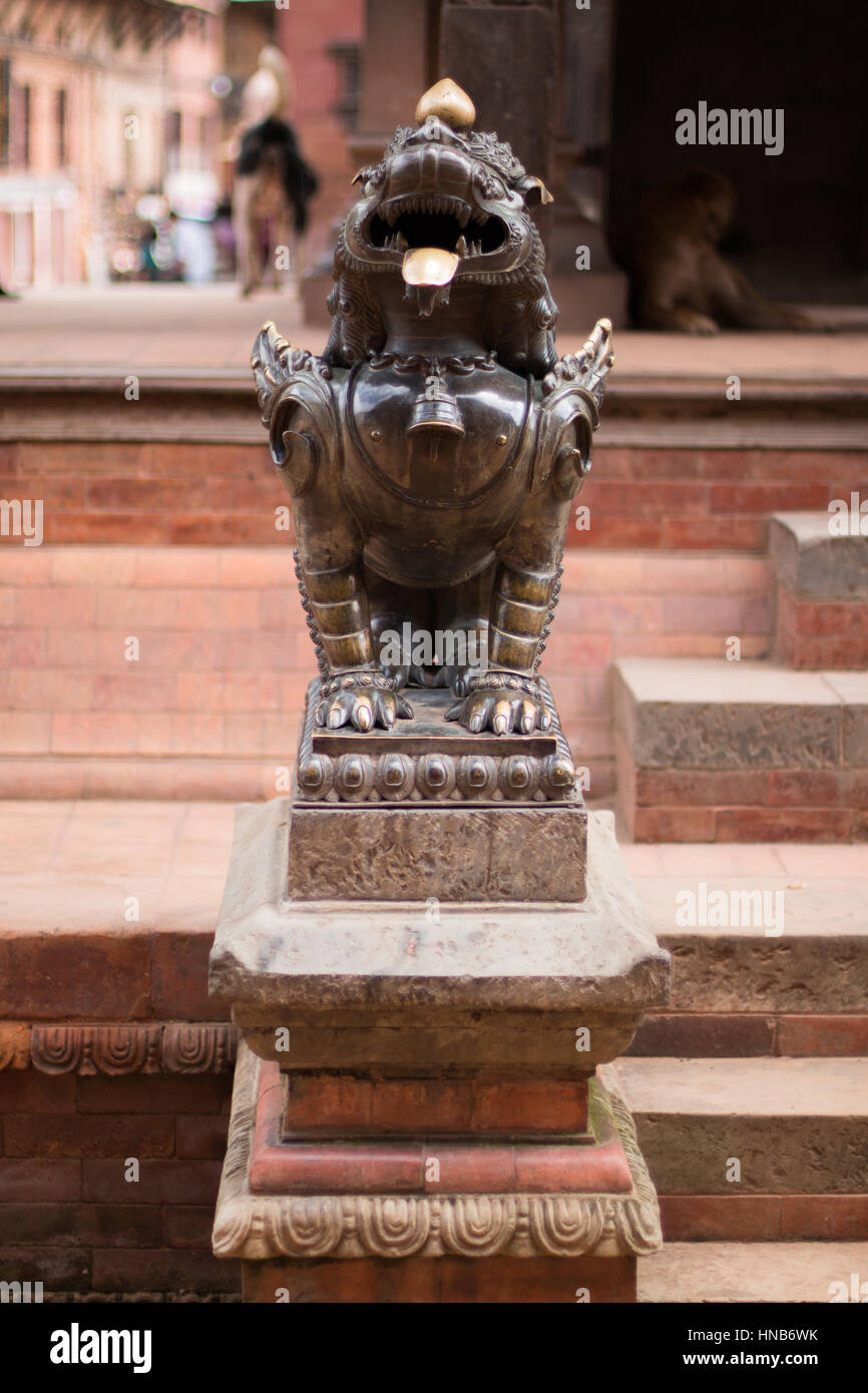 The bronze statue of a mythical winged lion guards a temple in ...