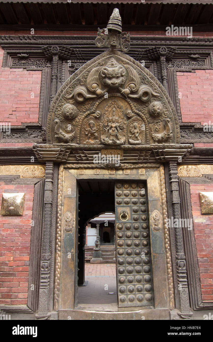 Ornately carved lintel of a traditional Nepalese-style wooden doorway ...