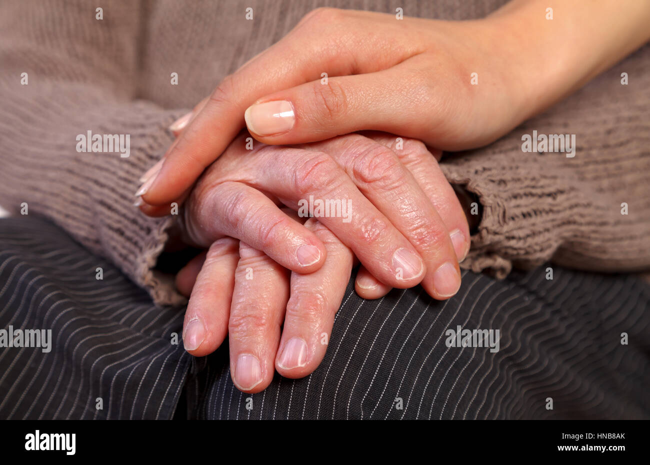 Nurse holding elderly wrinkled hand Stock Photo - Alamy