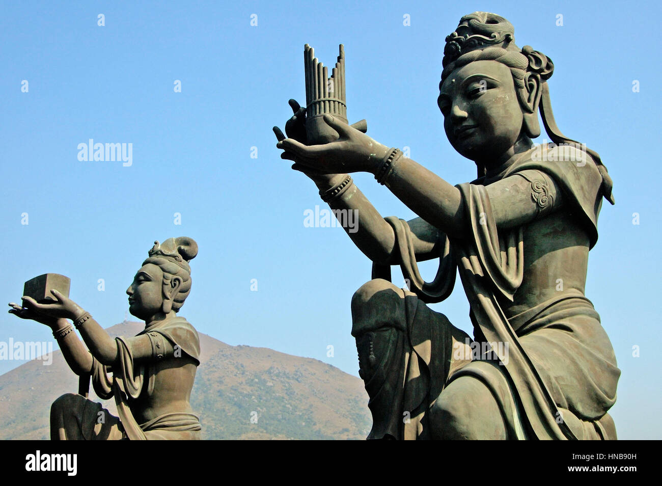 goddess offering lotus flower and gifts to Buddha Stock Photo - Alamy