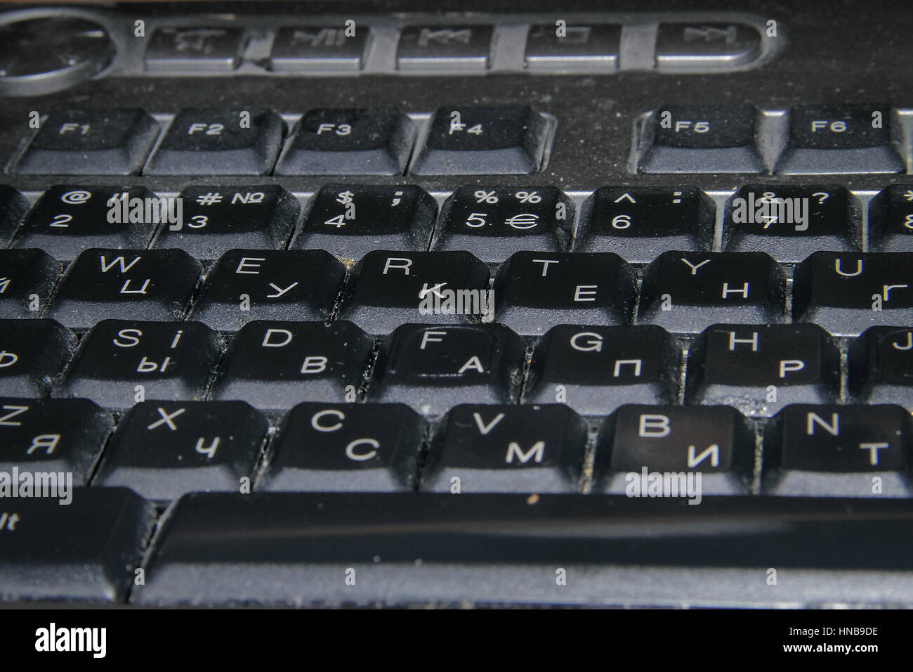 The dirty worn computer keyboard on the desk closeup Stock Photo - Alamy