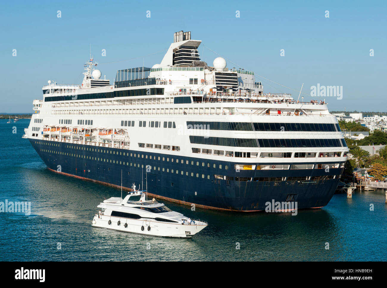 The small boat passing by the cruise liner docked in Key West town ...