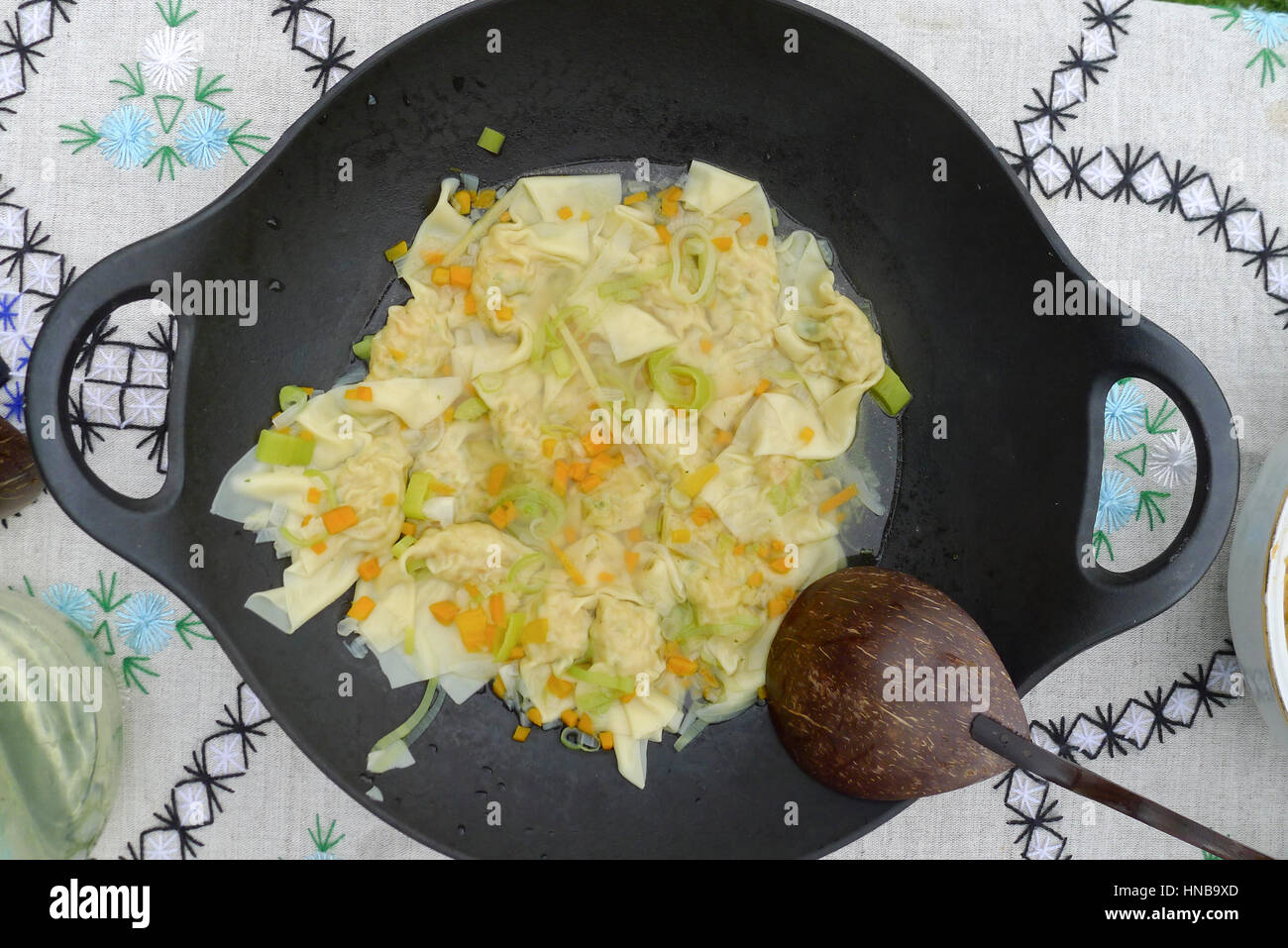 traditional asian food in a wok pan for dinner Stock Photo - Alamy