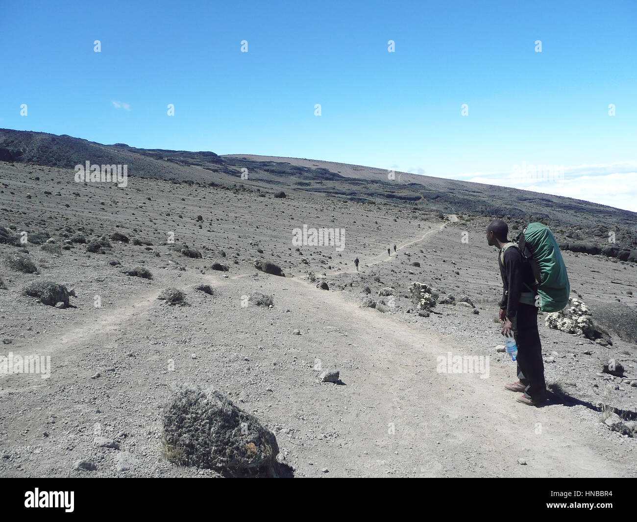 MOSHI,TZ - CIRCA AUGUST,2010 - Local guide shows the trail to Barafu ...