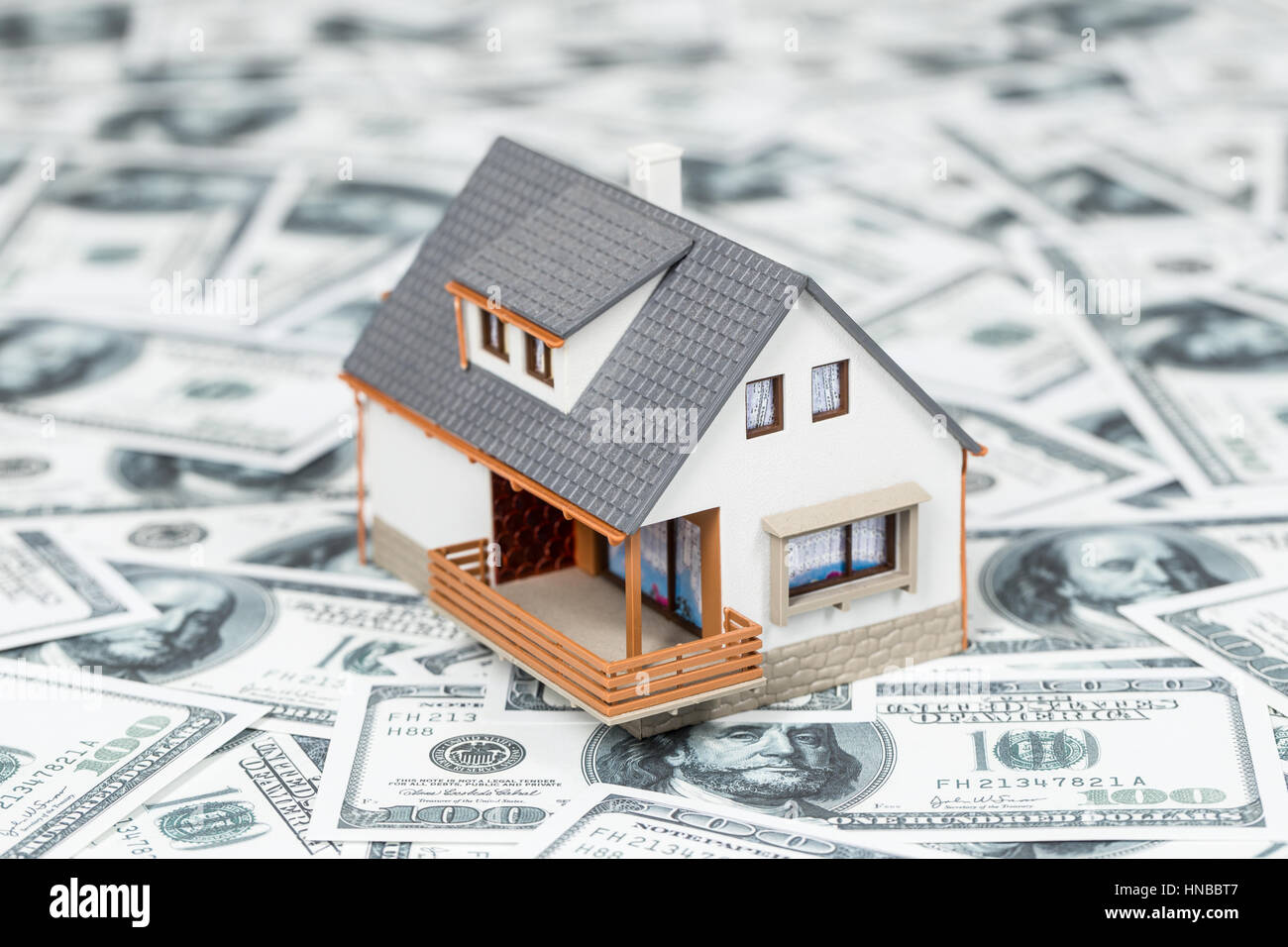 Beautiful house standing on dollar bills. Home expenses concept Stock ...
