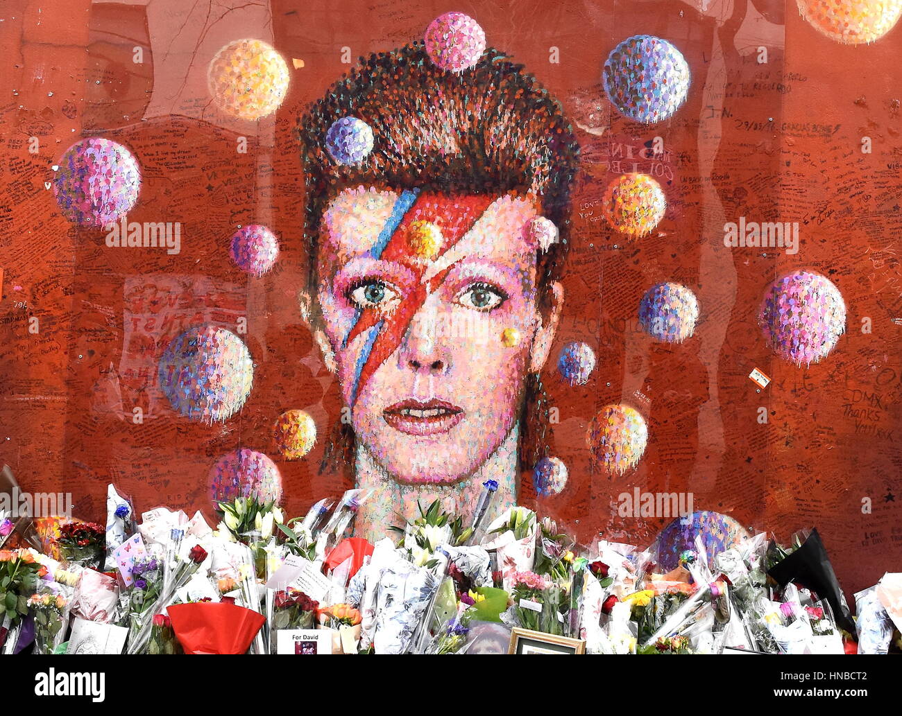 Tributes are laid at the mural of David Bowie in Brixton, south London ...