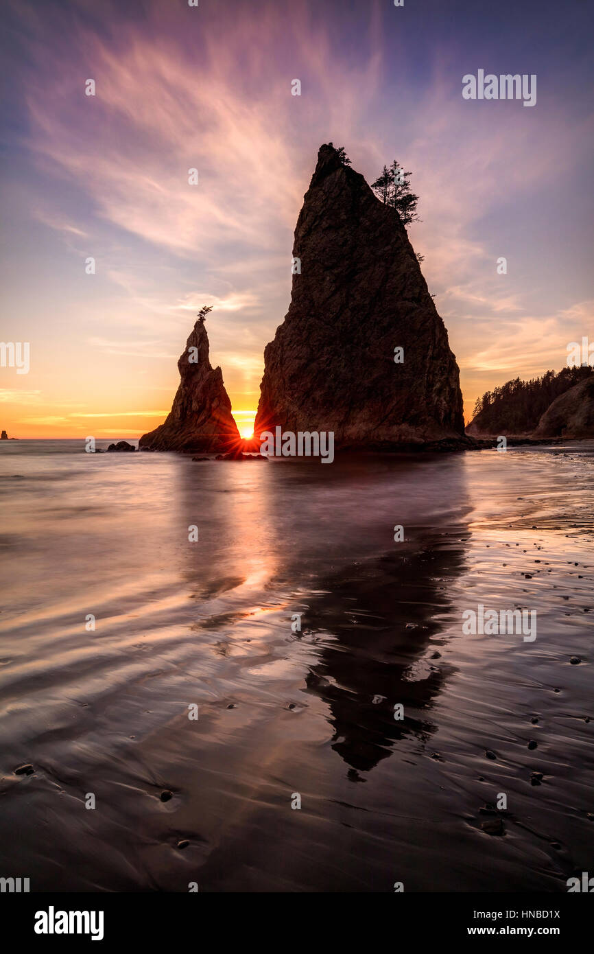 Sun setting in between two popular sea stack at Rialto Beach in Olympic ...