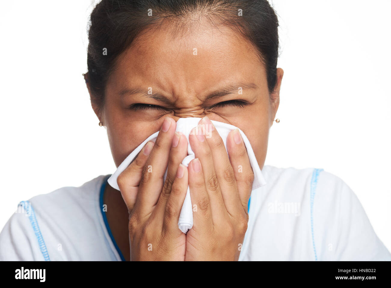 young woman with tissue blowing her nose isolated on white Stock Photo ...