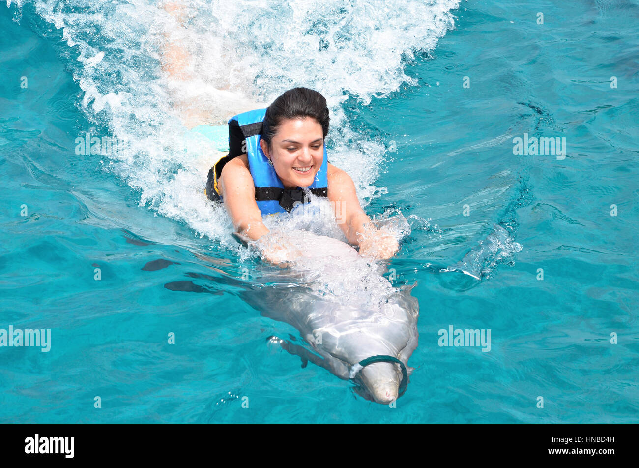 Woman riding dolphin hi-res stock photography and images - Alamy