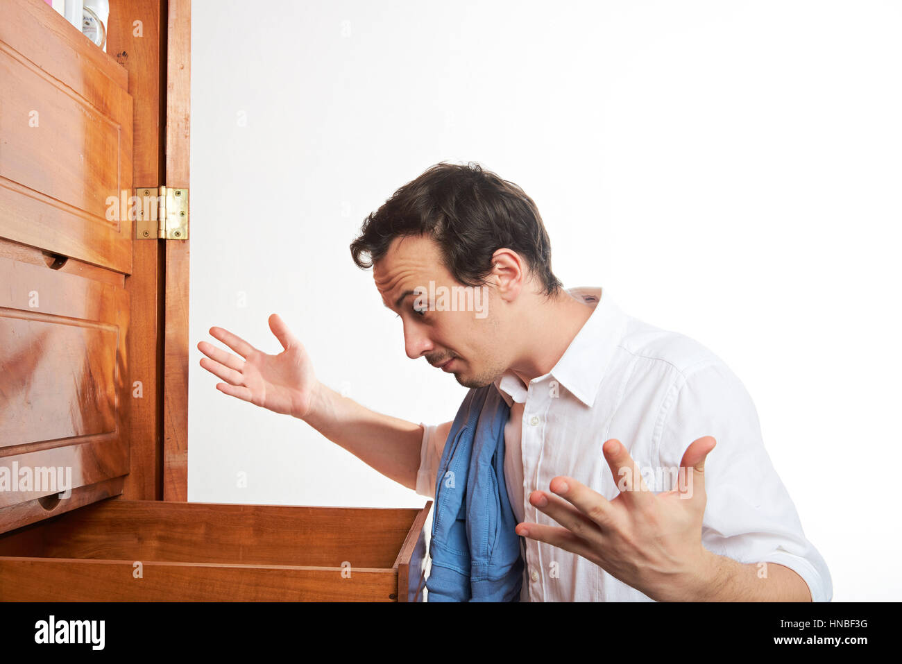 young man with empty wardrobe isolated on white background Stock Photo ...