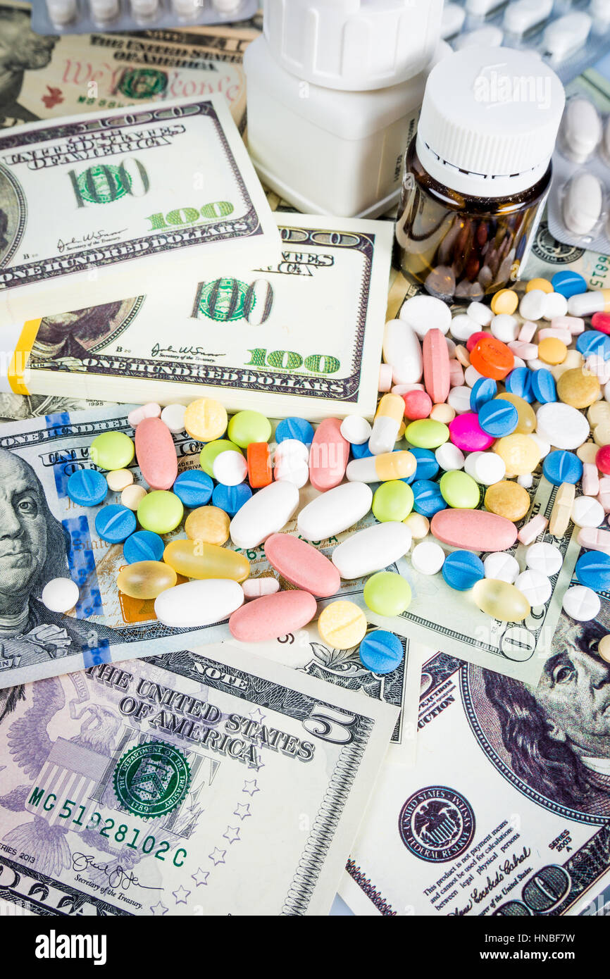 drugs on a money background. Money and pills Stock Photo - Alamy