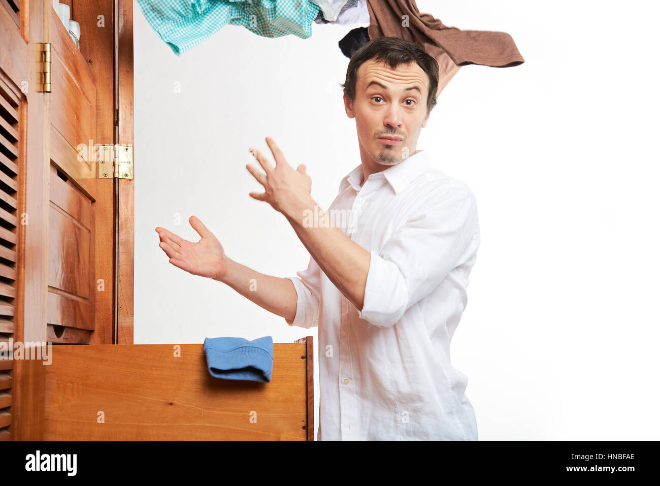 man with flying clothes from wardrobe isolated on white Stock Photo - Alamy