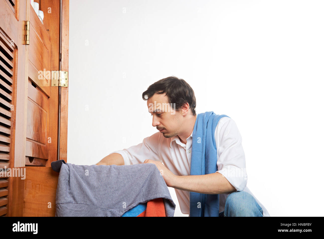 Man choosing shirt from wardrobe hi-res stock photography and images ...