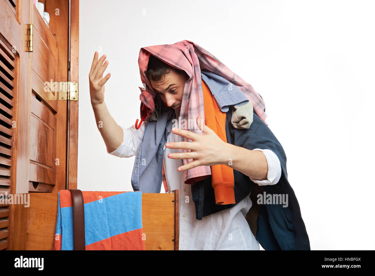 man with his wardrobe looking for clothing Stock Photo - Alamy