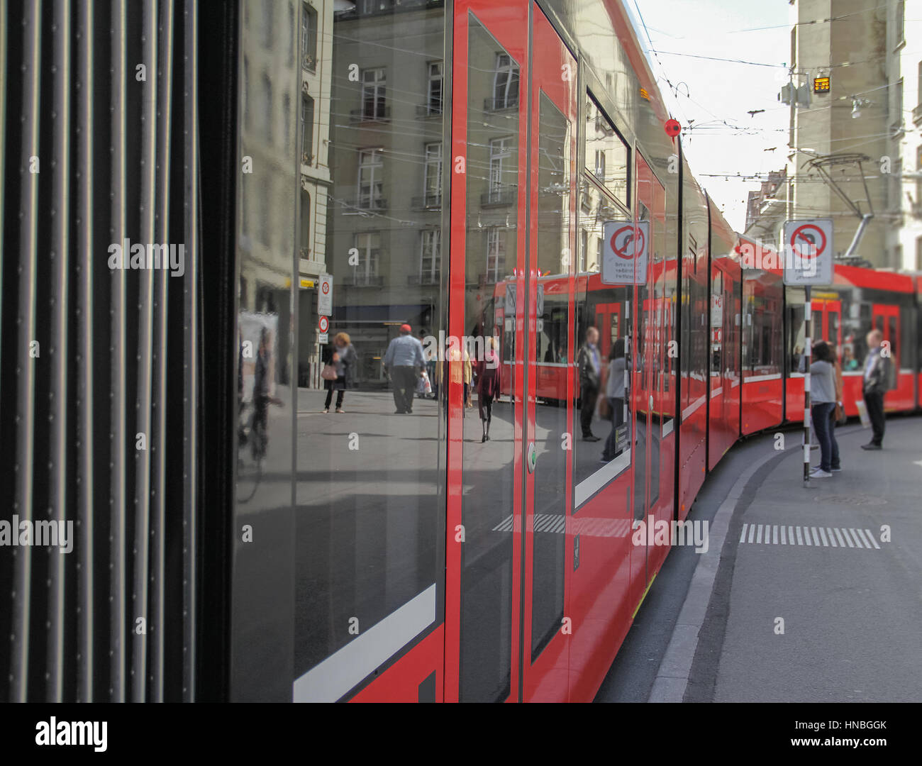 A beautiful modern red tram running on rails Stock Photo - Alamy