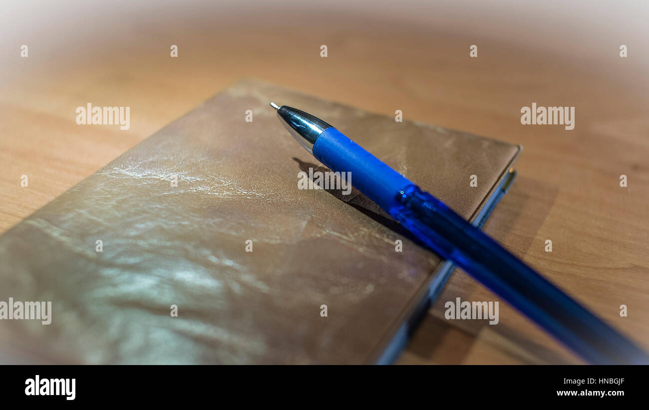 The blue ink ballpoint pen and documents on wooden desk closeup Stock ...