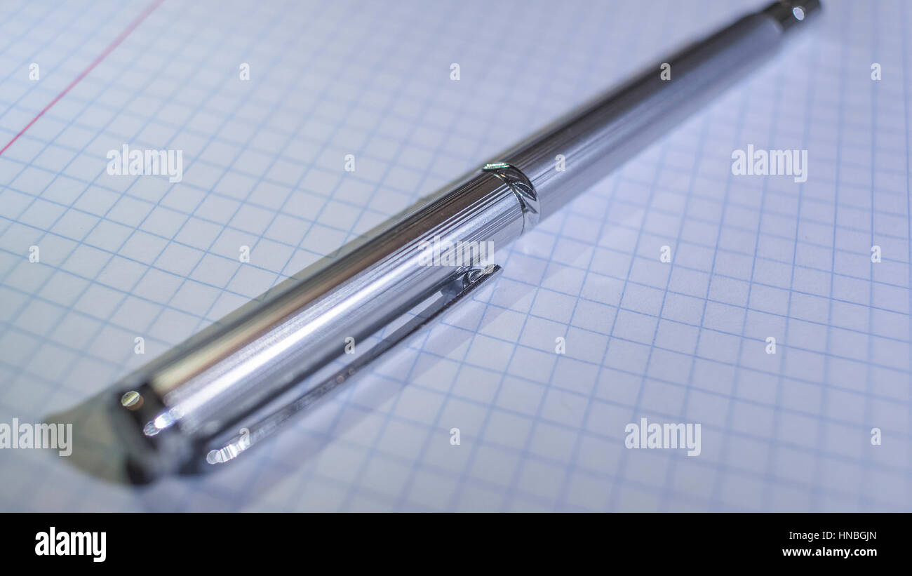 The shiny expensive metal pen on a notebook in the box Stock Photo - Alamy
