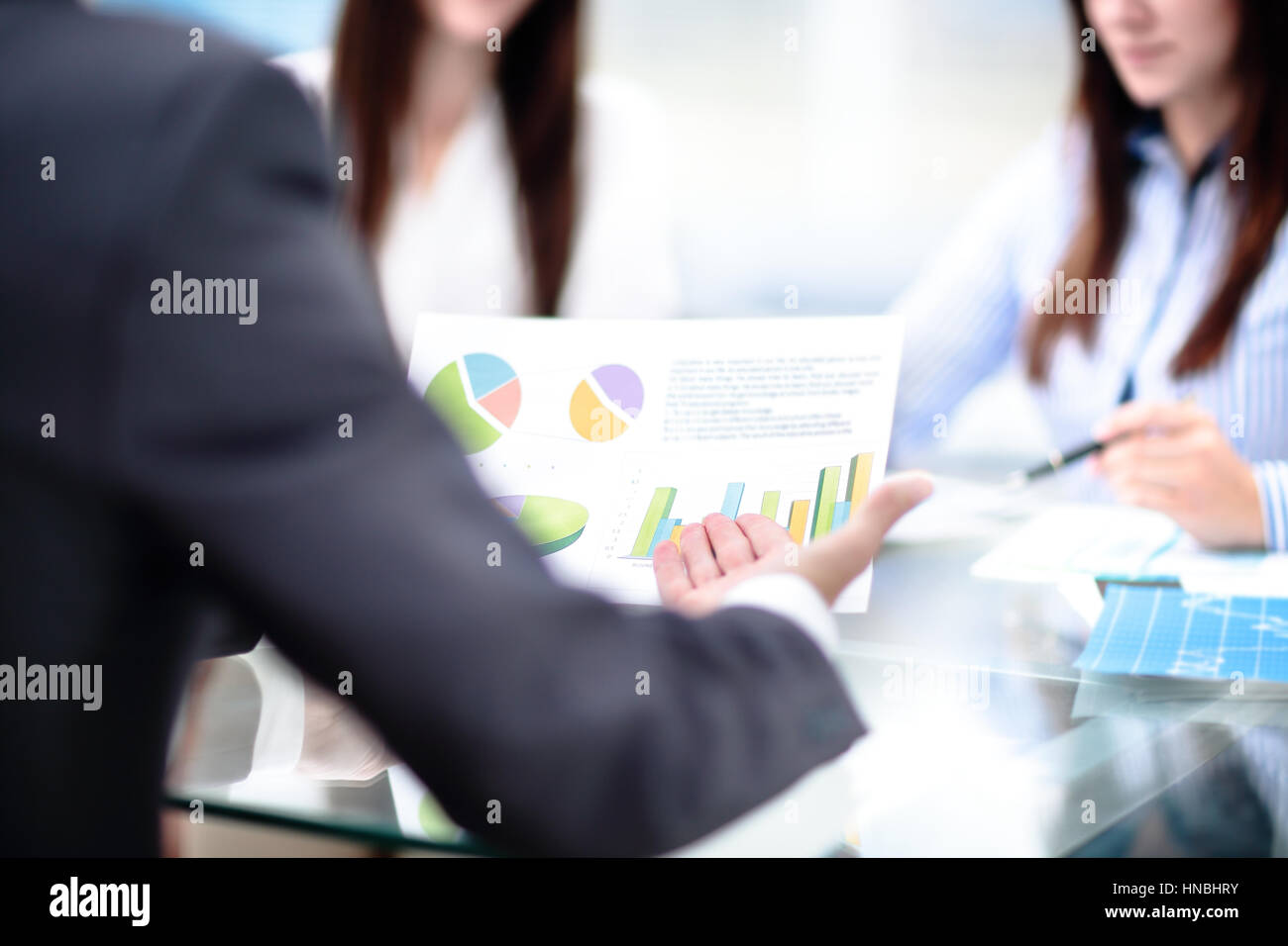 businessman hand pointing at graph document during discussion at ...