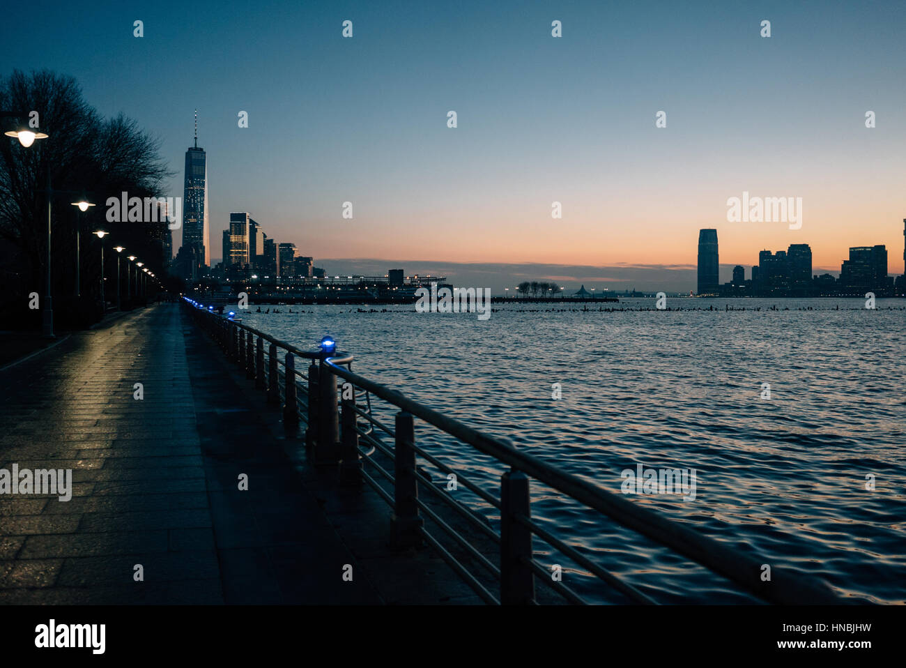 Waterfront promenade and modern buildings at night Stock Photo - Alamy